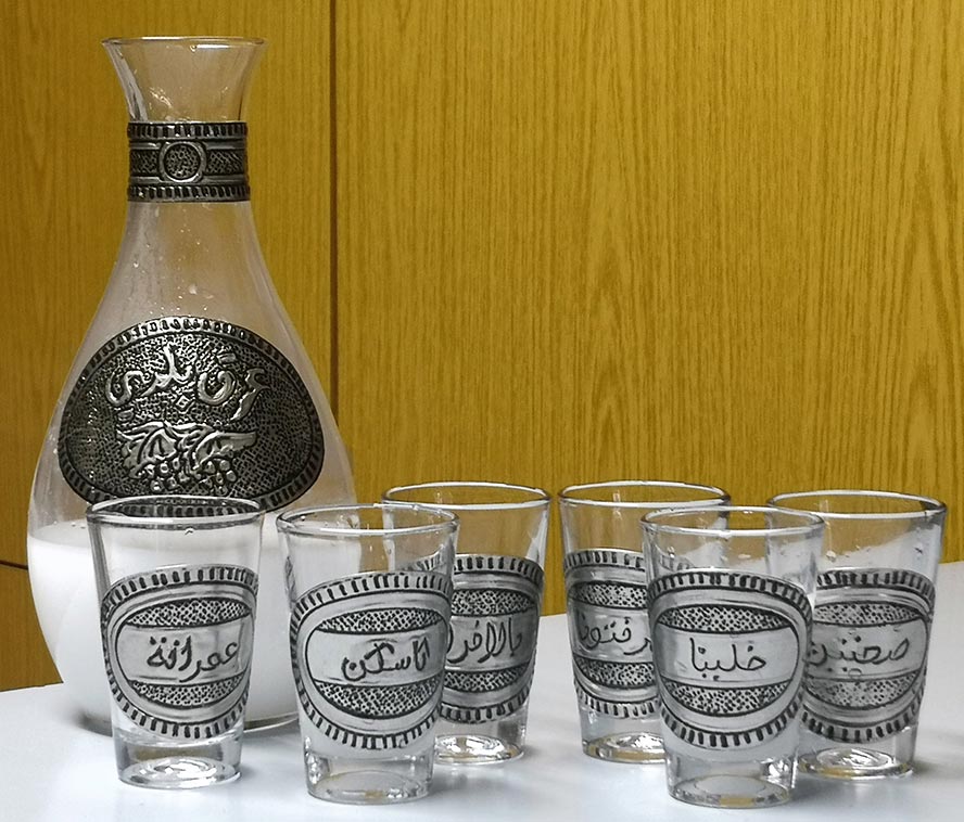 Set fine glass decorated plates of metal in bas-relief jug and cups