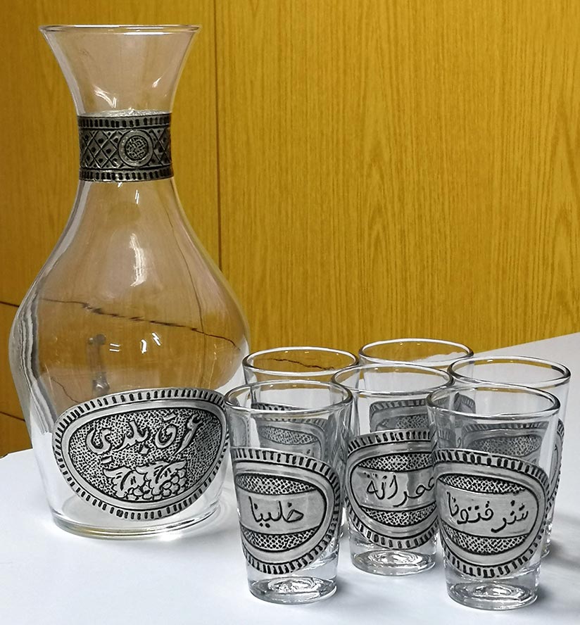 Set fine glass decorated plates of metal in bas-relief jug and cups